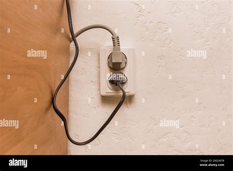 Two Plugs In The Socket In A Modern Interior Safe Connection Of Electrical Appliances Concept
