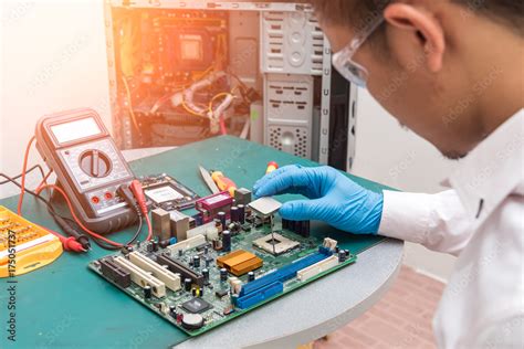 The Abstract Image Of The Asian Technician Putting A CPU In The CPU Socket In The Computer