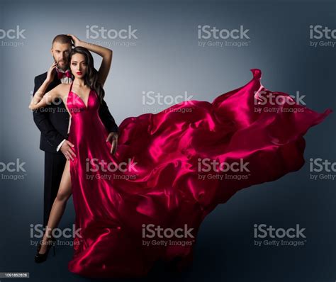 Fashion Couple Young Beautiful Woman In Flying Waving Dress And Elegant