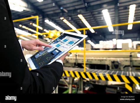 engineer hand using tablet with machine real time monitoring system