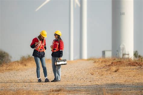 Premium Photo Both Female Engineers And Wind Turbines In A Wind Farm In The Countryside Of