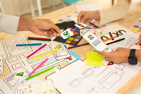 A Team Of UI UX Web Designers Is Working Together To Develop A Mobile Responsive Website With