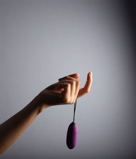 Vertical Shot Of The Female Holding The Purple Sex Toy Vibrator Stock