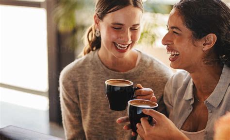 Two Friends Having Coffee Together In A Coffee Shop Best Friends