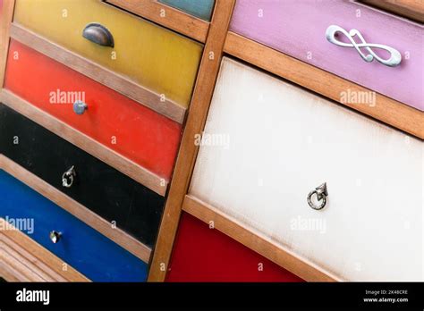 Commode Drawers With Colorful Panels And Different Types Of Handles