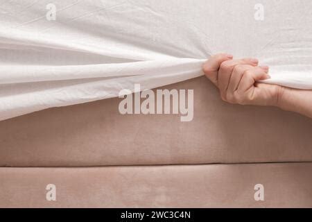 Changing Bed Sheets Woman Is Putting On A Fitted White Cotton Sheet On A Mattress While Making
