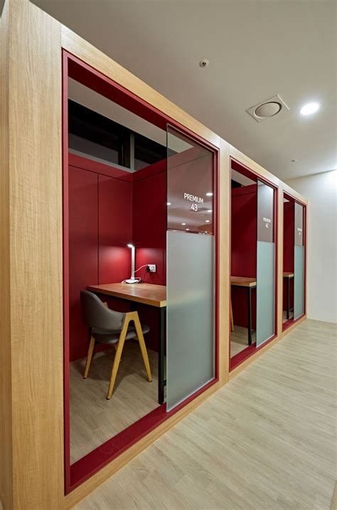 An Office With Red Walls And Glass Partitions