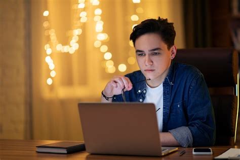 Premium Photo Pensive Young Caucasian Guy Developer Working On Laptop