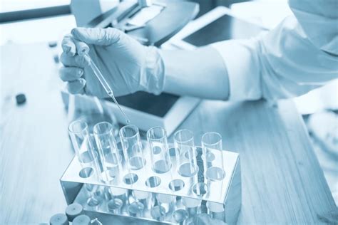 Premium Photo Midsection Of Scientist Performing Scientific Experiment