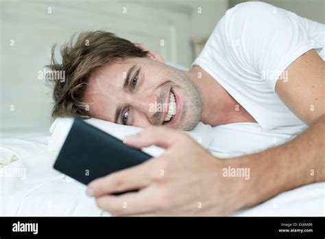 Man In Bed Using Hi Res Stock Photography And Images Alamy