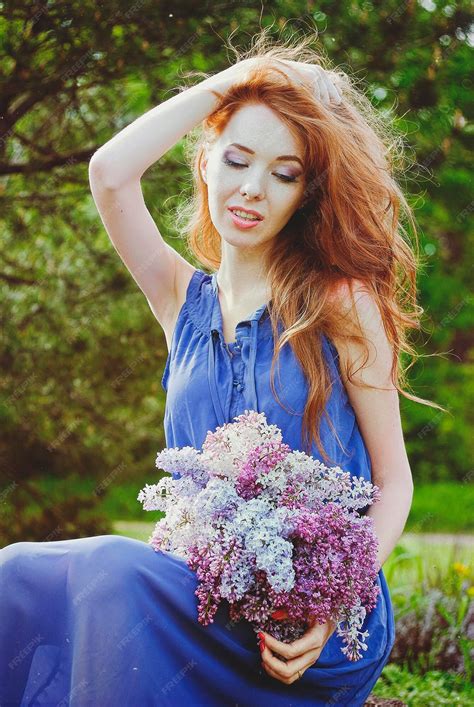 Premium Photo Young Redhead Woman In Spring Garden With Freckles