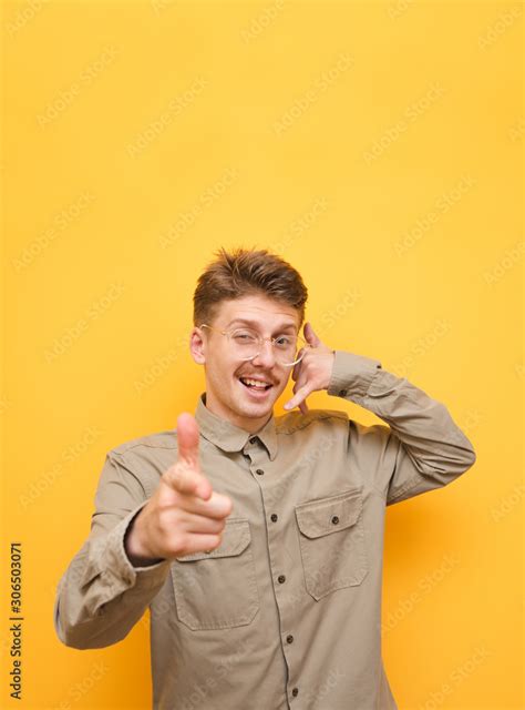 Photo Stock Vertical Photo Funny Nerd In A Shirt And Glasses Stands On A Yellow Background
