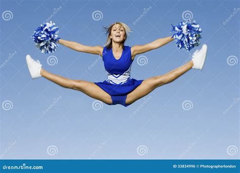 Cheerleader With Pompoms Doing Splits Against Sky Royalty Free Stock Image Image 33834996