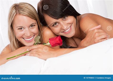 Portrait Of Two Smiling Women Lying Down In Bed Stock Image Image Of