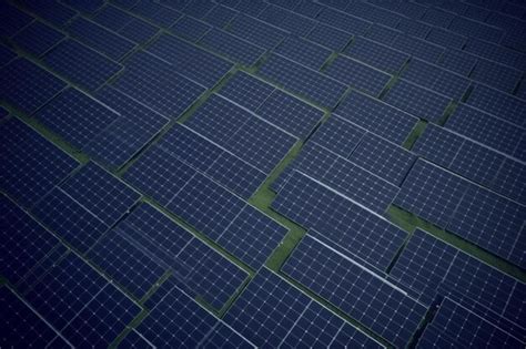 Premium Ai Image A Large Array Of Solar Panels In A Field