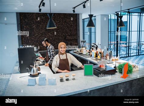Muslim Waitress Or Owner And Partner Portrait Smiling To Camera Stock