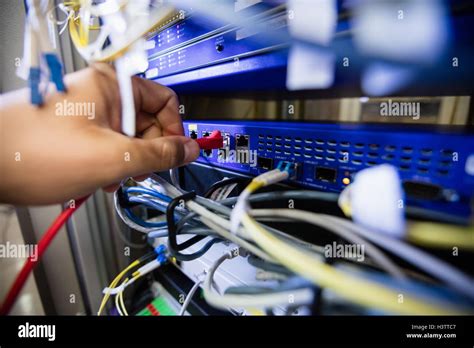 Technician Fixing Patch Cable In A Rack Mounted Server Stock Photo Alamy