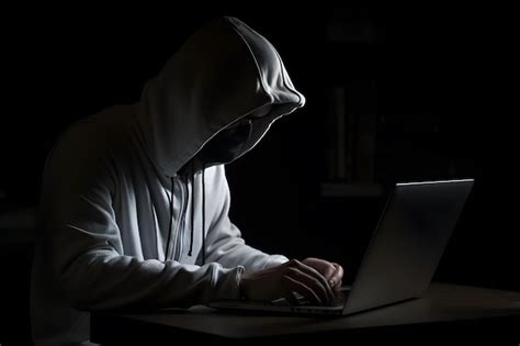 premium ai image mysterious hacker wearing a hoodie is typing on a laptop generative ai