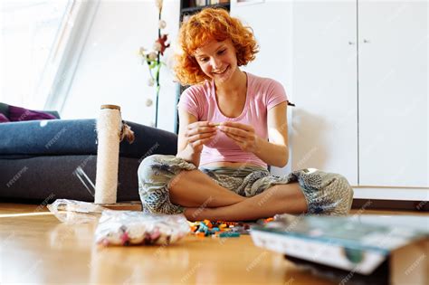 Premium Photo Teenage Girl Assembles Construction Set According To