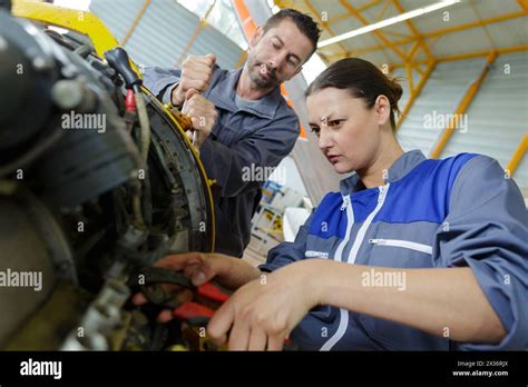 Female And Male Mechanic Fixing A Compressor Engine Stock Photo Alamy