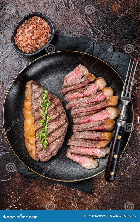 Sliced Grilled Medium Rare Top Sirloin Beef Steak On A Plate Dark