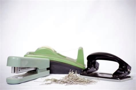 Premium Photo Green Stapler And Black Stapler On A White Background