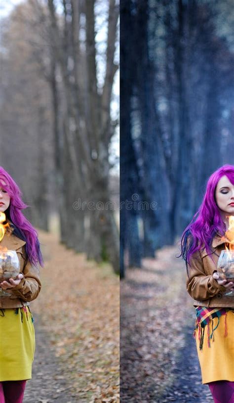Gothic Girl With Purple Hair Is Standing With A Burning Glass In Her