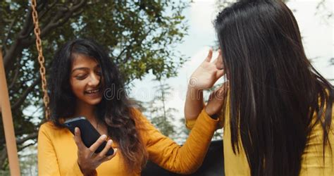 Indian Girls Are Scrolling On The Smartphone And Having Fu Stock Photo Image Of Curious Relax