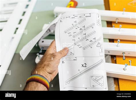 Hand Holding An Generic Illustrated Furniture Assembly Instruction