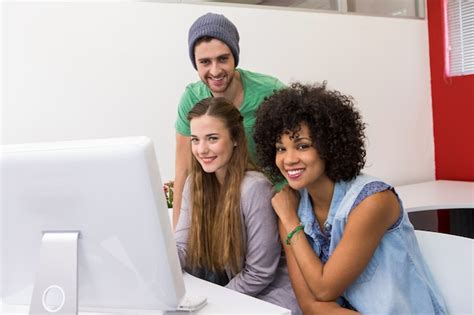 Premium Photo Portrait Of Team At Computer Desk
