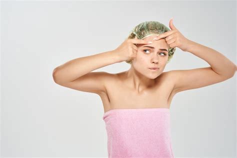 Premium Photo Woman Squeezes Pimples On Her Forehead Bathroom High Quality Photo