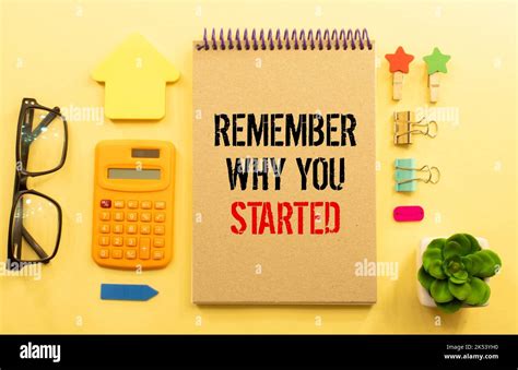 Remember Why You Started Text Like Planning On Notepad And Wooden Table With Clock Stock Photo