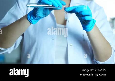 Scientist Woman Pouring Liquid Into Medical Spectro In Laboratory Or Hospital Sample Filling In