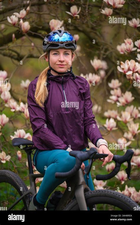 Female Cyclist In Sports Uniform Helmet Standing With Gravel Bike Near