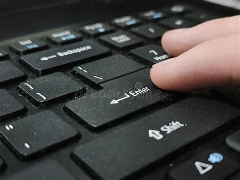 Close Up Of A Human Finger Pressing The Enter Key On A Black Computer