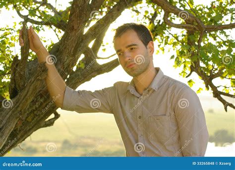 Man Under Tree Stock Photo Image Of Brunette Pants
