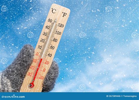 Wooden Celsius And Fahrenheit Scale Thermometer In Hand Ambient