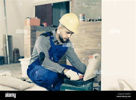 Diligent Efficient Serious Builder Is Choosing Tools In Suitcase For Work At The Object Stock