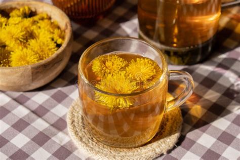 Dandelion Flower Healthy Tea In Glass Teapot And Glass Cup On Table