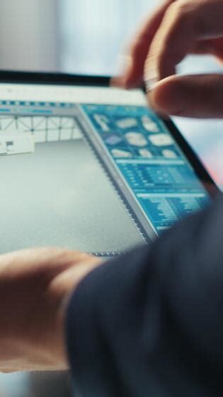 Vertical Photovoltaics Factory Technician Monitoring System Performance On Tablet Solar Panels