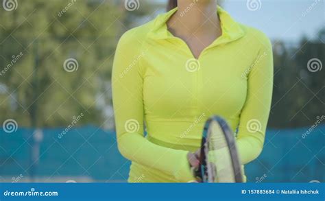 Unrecognized Girl In A Sportswear Holds A Tennis Racket While Standing