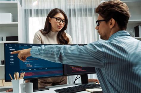 Woman Standing Opposite To Man Programmer Working On Desk To Discuss Postulate Stock Image