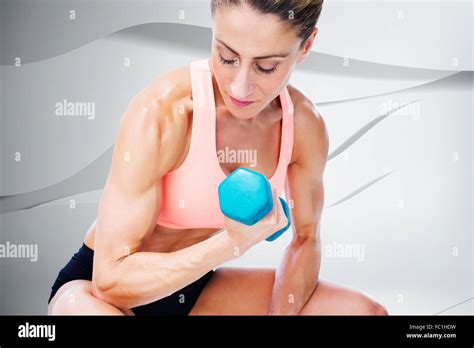 Composite Image Of Strong Woman Doing Bicep Curl With Blue Dumbbell Stock Photo Alamy