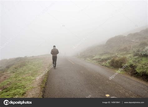 Man Walking Through Fog Stock Photo By Haveseen 145610841