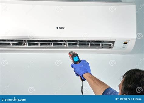 Technitian Checking Temperature By Infrared Thermometer Inside Of Gree Air Conditioner Editorial