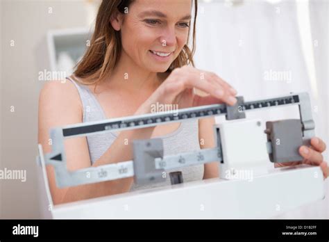 Woman Adjusting Medical Scale Stock Photo Alamy