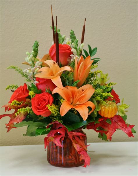 Vase Of Fall Flowers Including Orange Lilies Orange Roses And Yellow