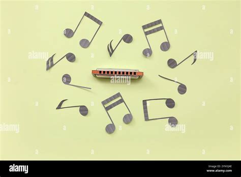 Composition With Harmonica And Music Notes On Color Background Stock