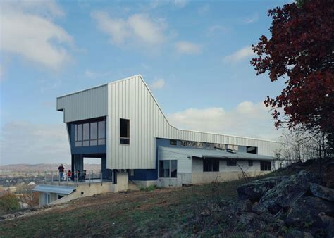 Angular Metal Roof Wraps Around Hilltop House By Demx Architecture