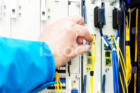 Man Connecting Network Cables To Switches Stock Photo Royalty Free Images FreeImages
